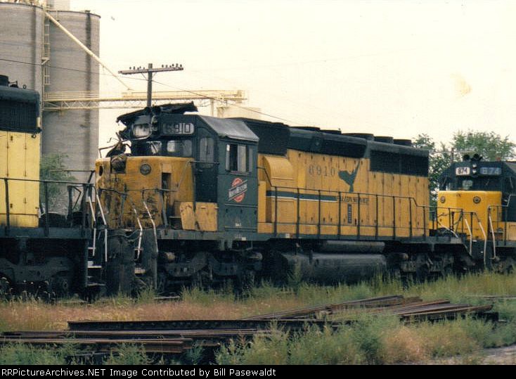 CNW 6910 sits, in bad shape, after a derailment
